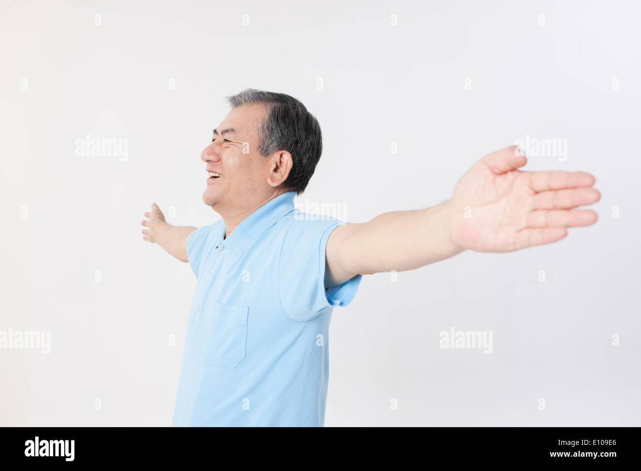 an old man stretching his arms out Stock Photo - Alamy