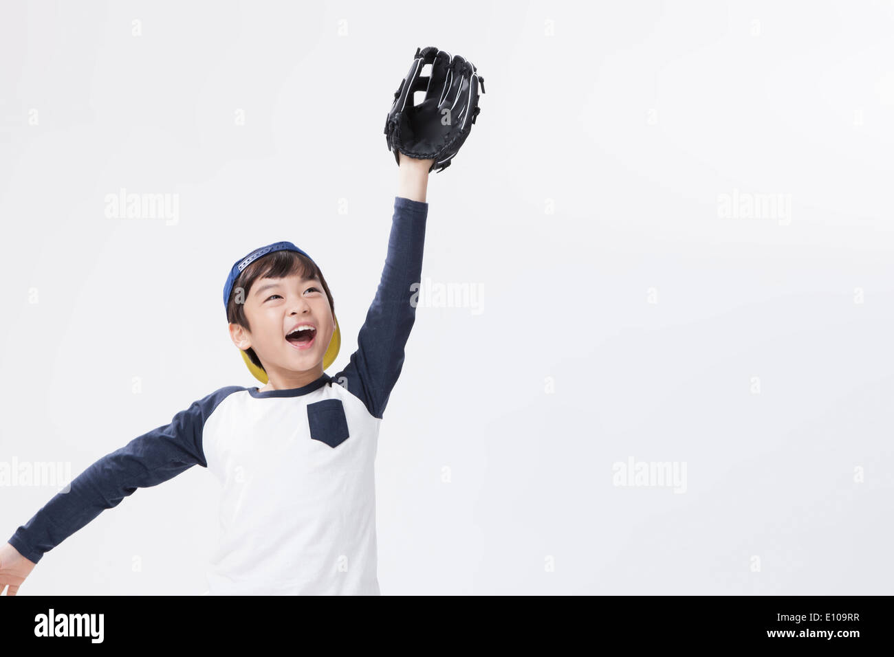 a young boy reaching high with a baseball mitt Stock Photo - Alamy