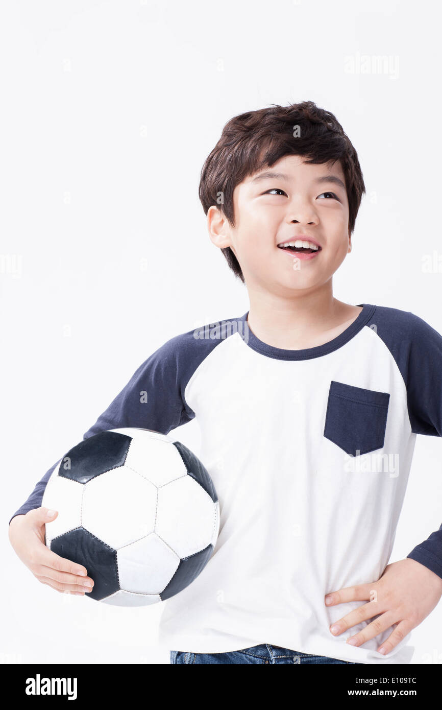 a young boy posing with a football Stock Photo - Alamy