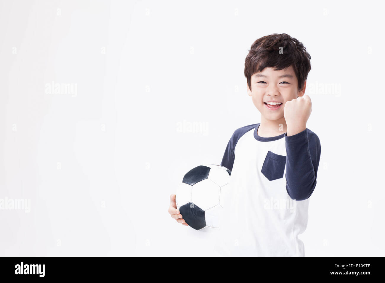 a young boy posing with a football Stock Photo - Alamy