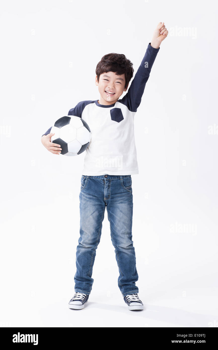 a young boy posing with a football Stock Photo - Alamy