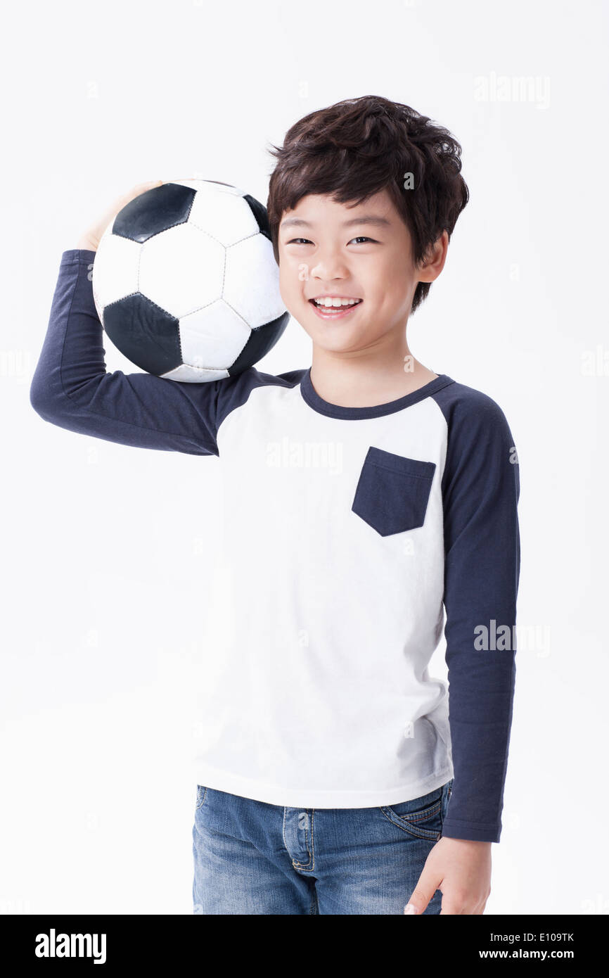 a young boy posing with a football Stock Photo - Alamy