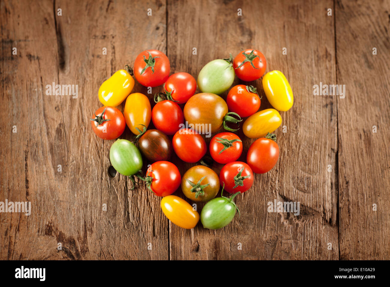 several different color mini tomatoes in a heart shape Stock Photo - Alamy