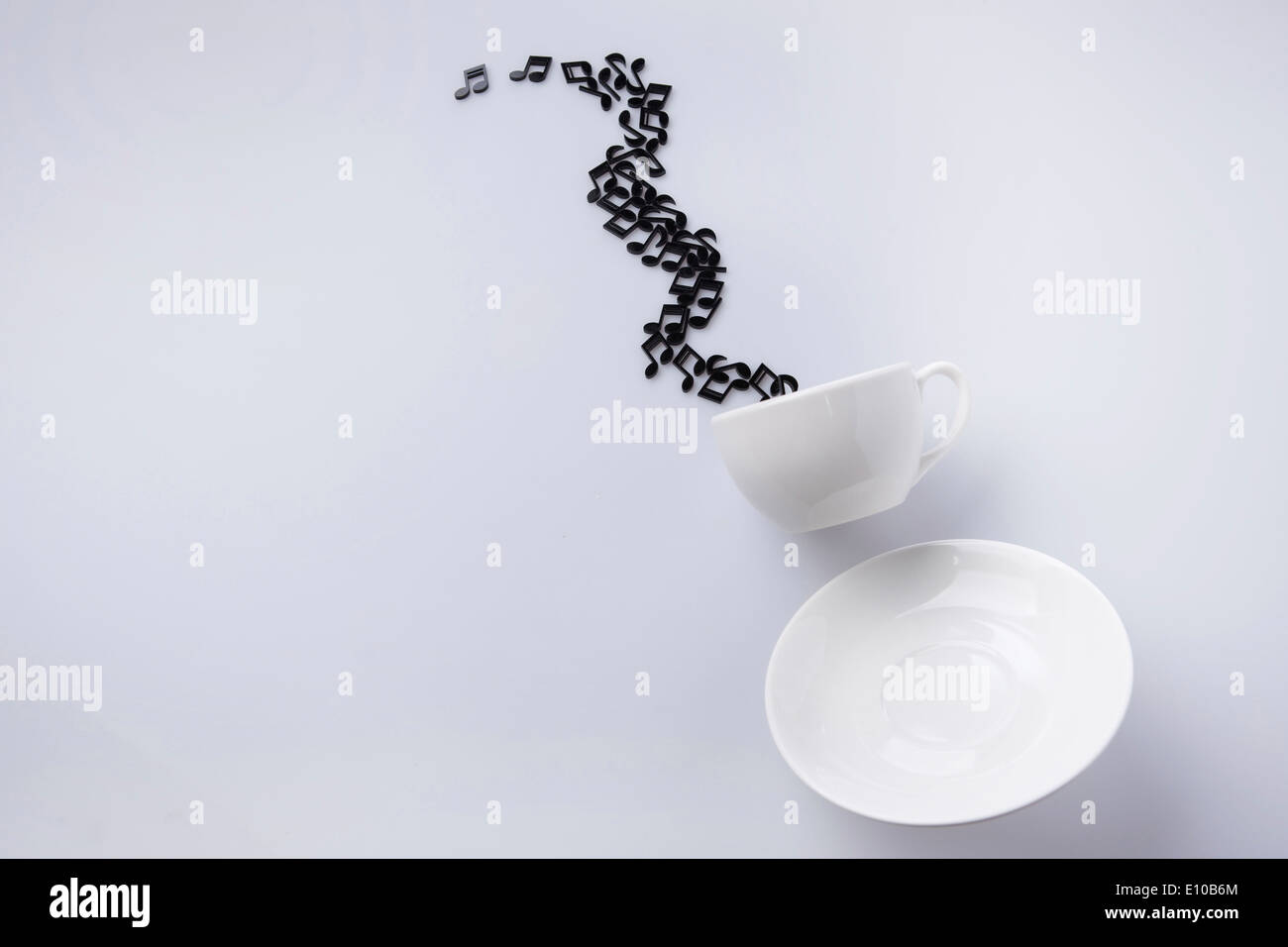 a coffee cup on its side with musical notes coming out Stock Photo - Alamy
