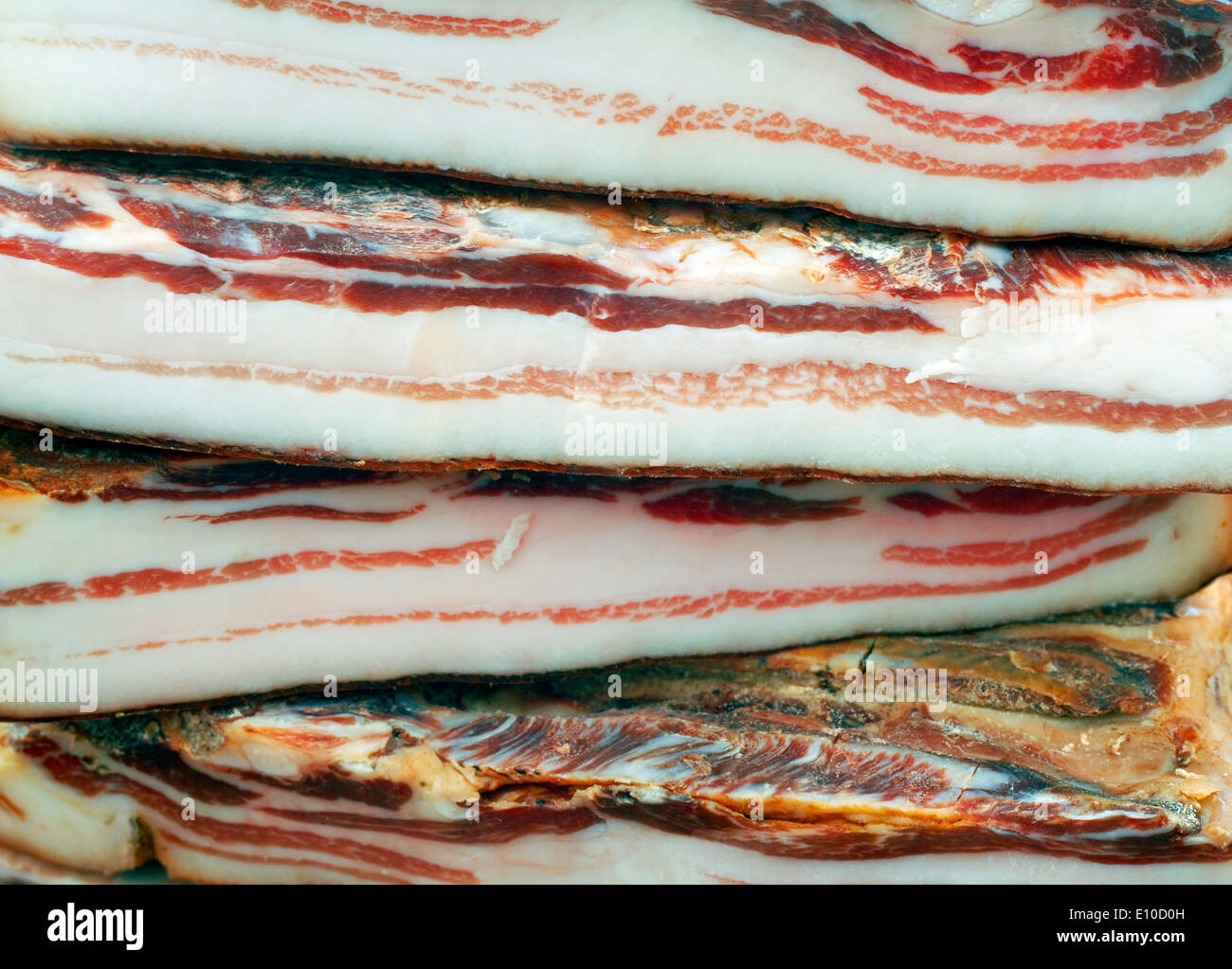 Stack of Dry Raw Smoked Bacon Background Stock Photo - Alamy