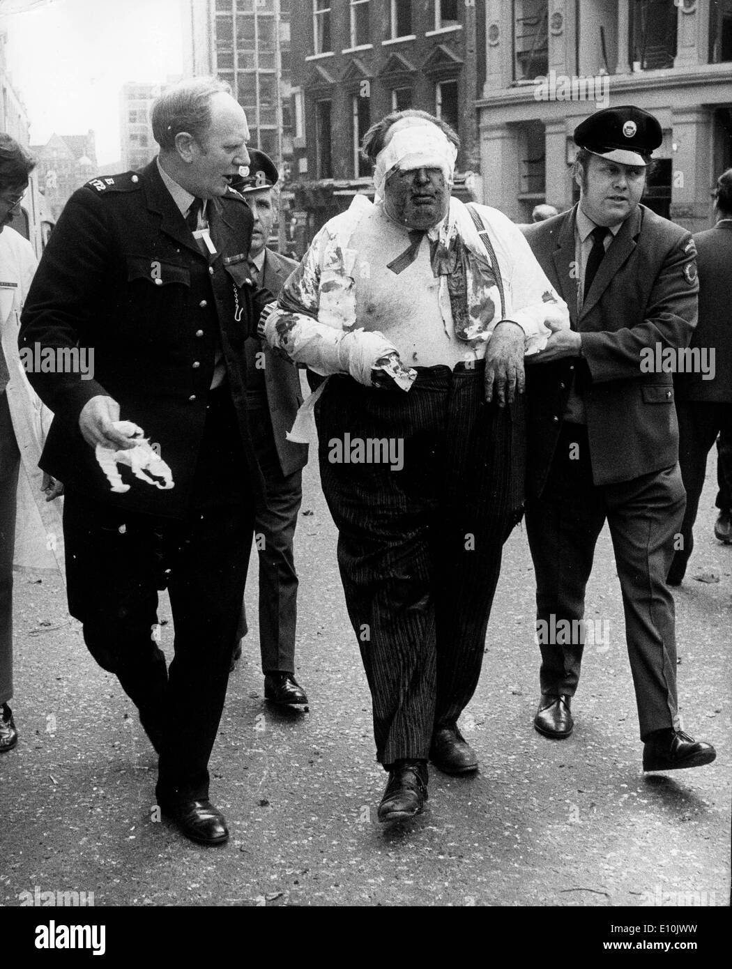 An injured man is led away from the scene, after the explosion outside ...