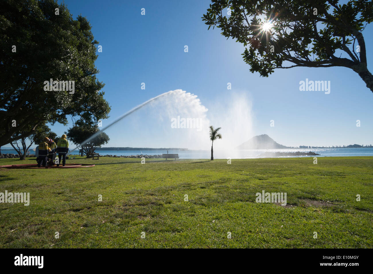 Firemen test their hose on Tauranga's Sulphur Point, New Zealand Stock ...
