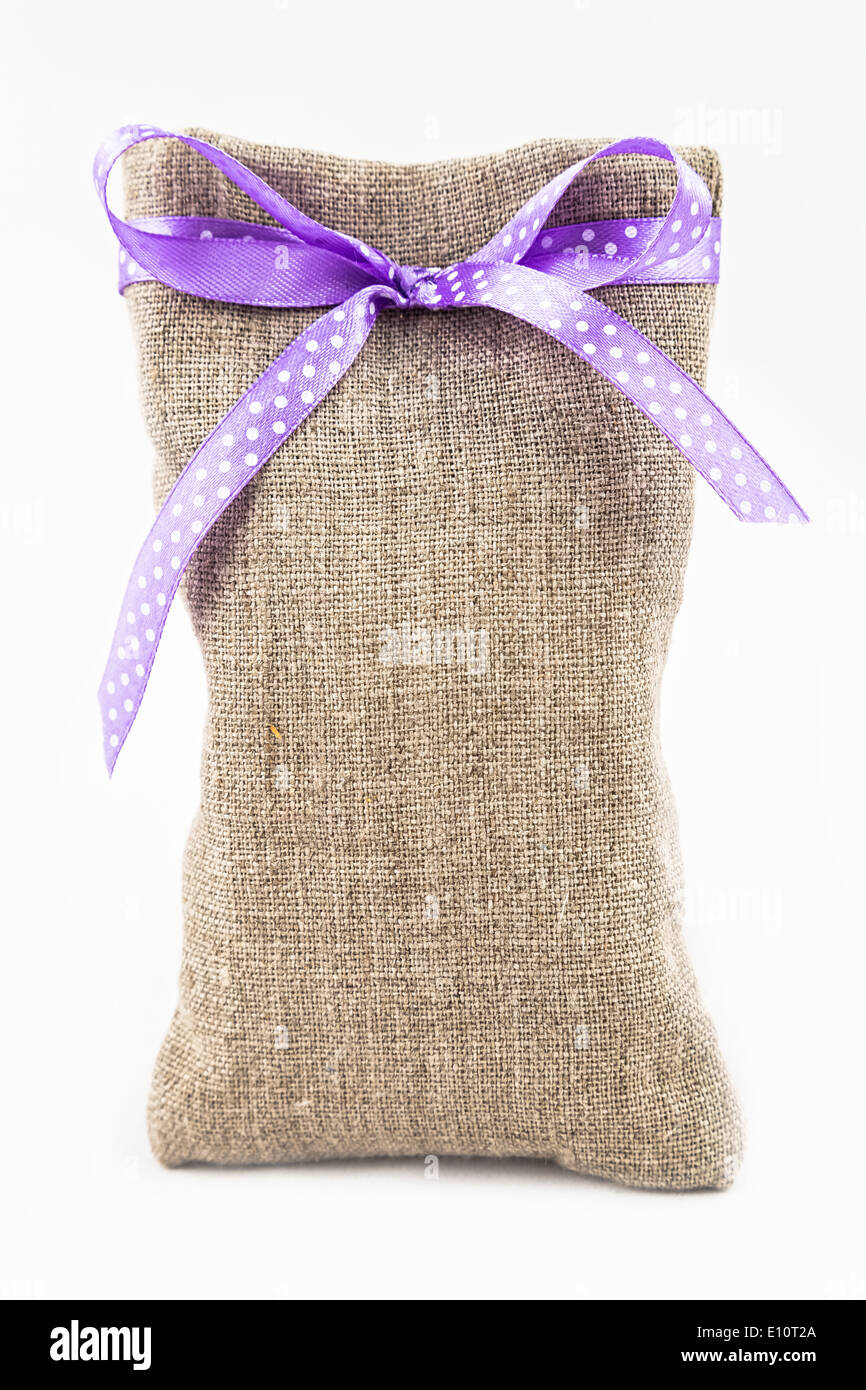 Decorative textile sachet pouch with a ribbon and bow on white ...