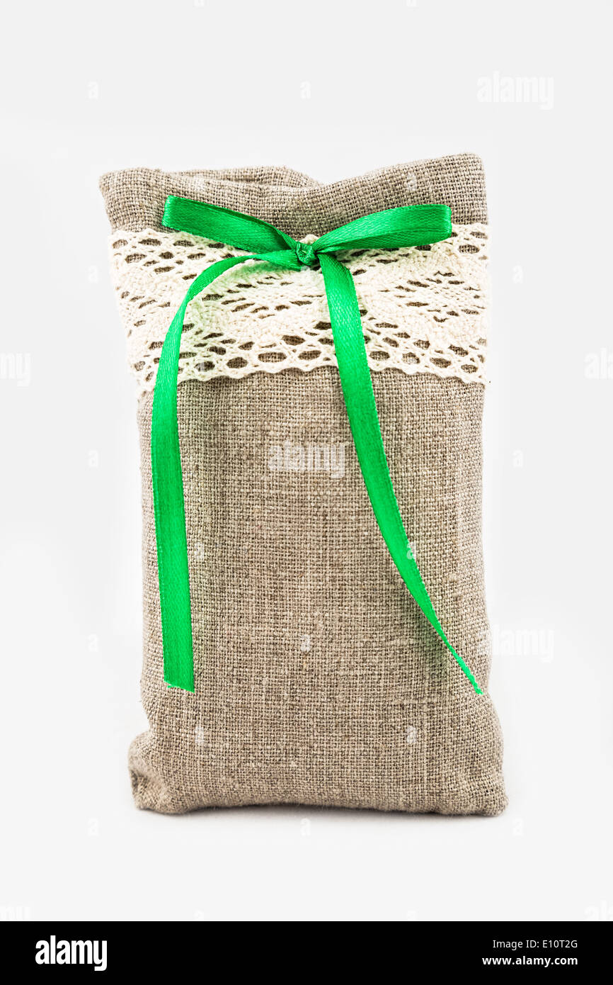 Decorative textile sachet pouch with a ribbon and bow on white ...