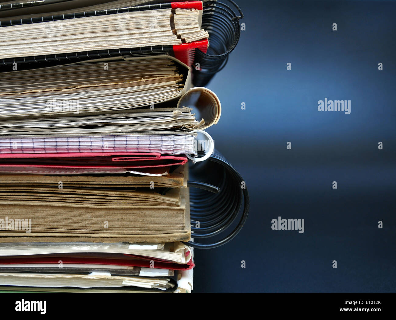 Stack of office folders on black wall Stock Photo - Alamy