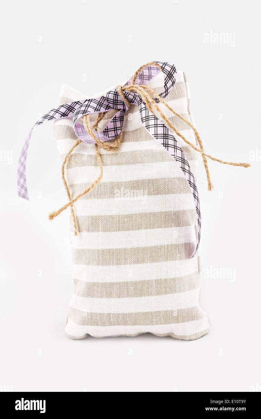 Decorative textile sachet pouch with a ribbon and bow on white ...