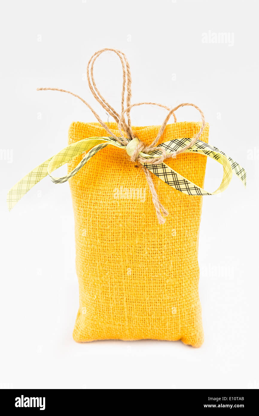Decorative textile sachet pouch with a ribbon and bow on white ...
