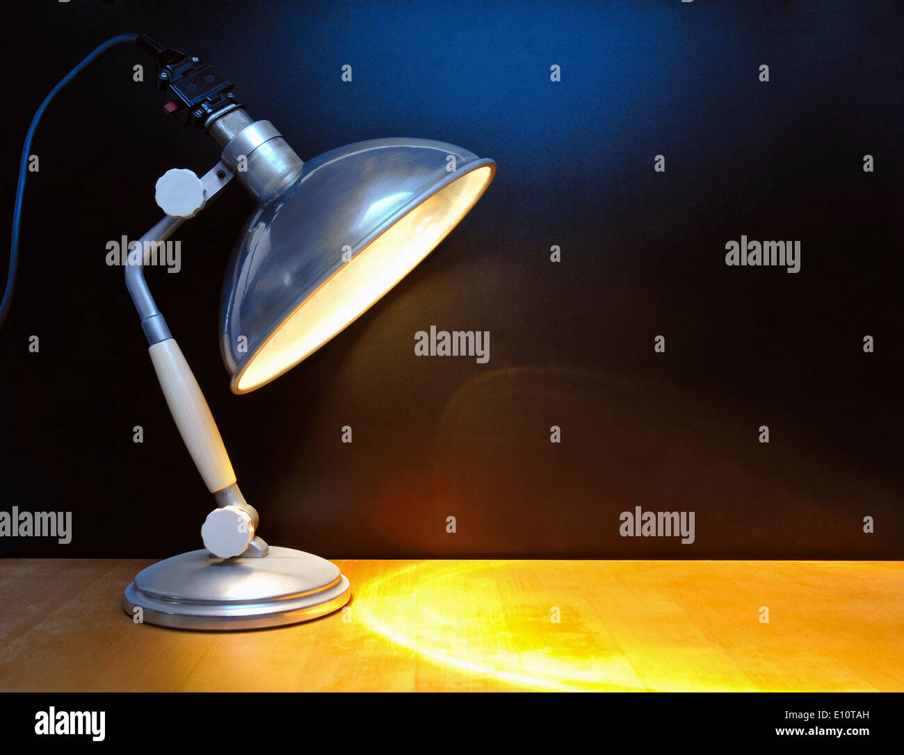 Vintage lamp on a desk in front of black wall Stock Photo - Alamy