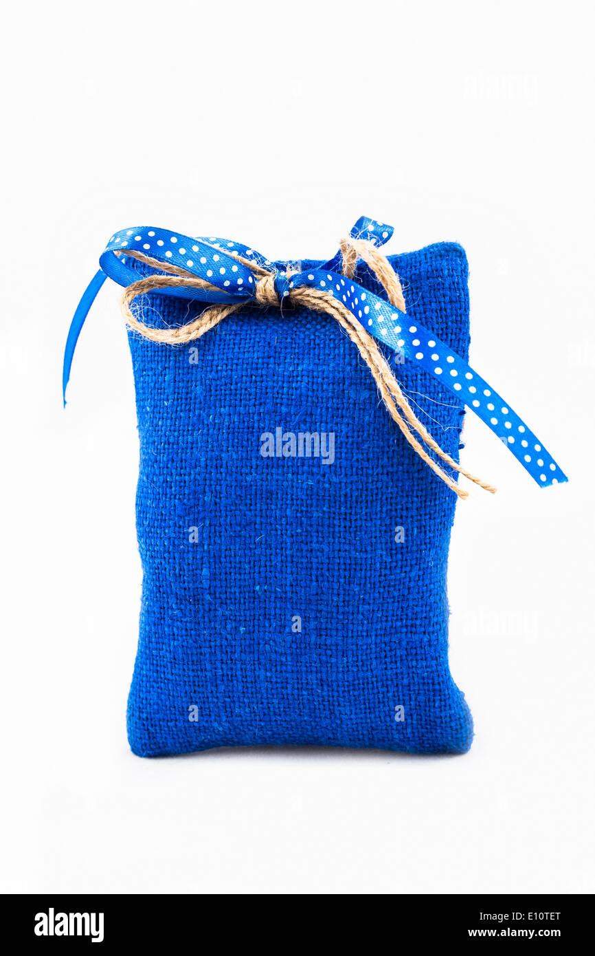 Decorative textile sachet pouch with a ribbon and bow on white ...
