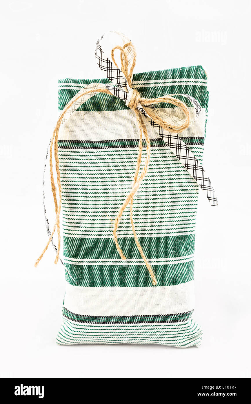 Decorative textile sachet pouch with a ribbon and bow on white ...