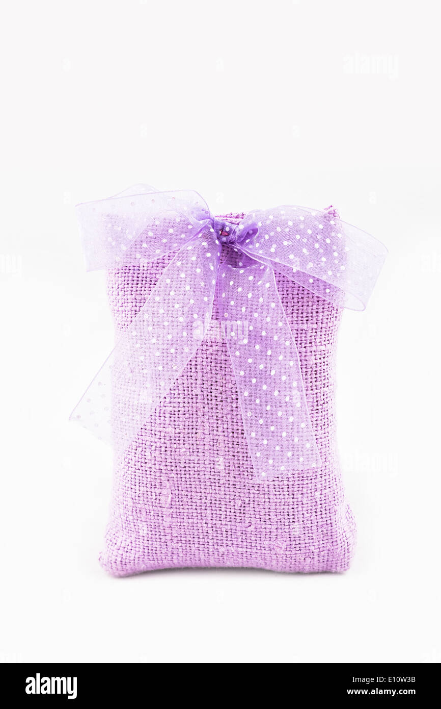 Decorative textile sachet pouch with a ribbon and bow on white ...