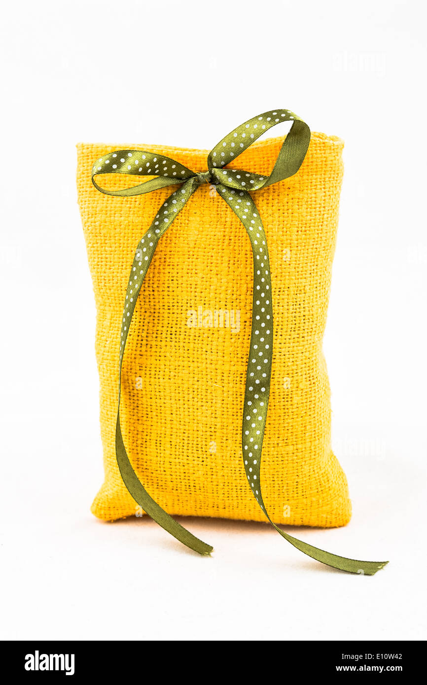 Decorative textile sachet pouch with a ribbon and bow on white ...