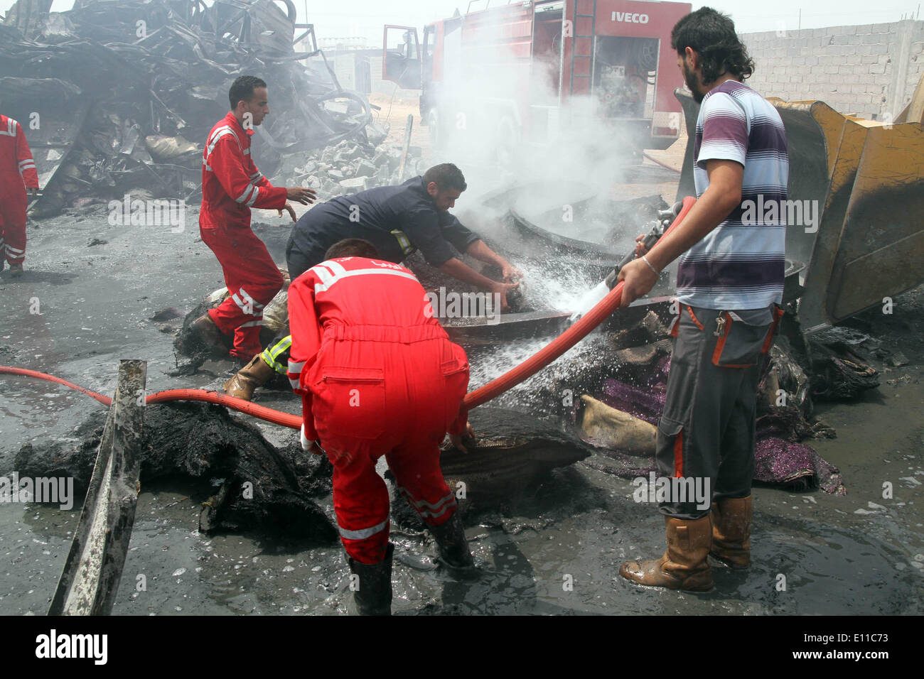 Tripoli, Libya. 21st May, 2014. Firefighters extinguish fire at the ...