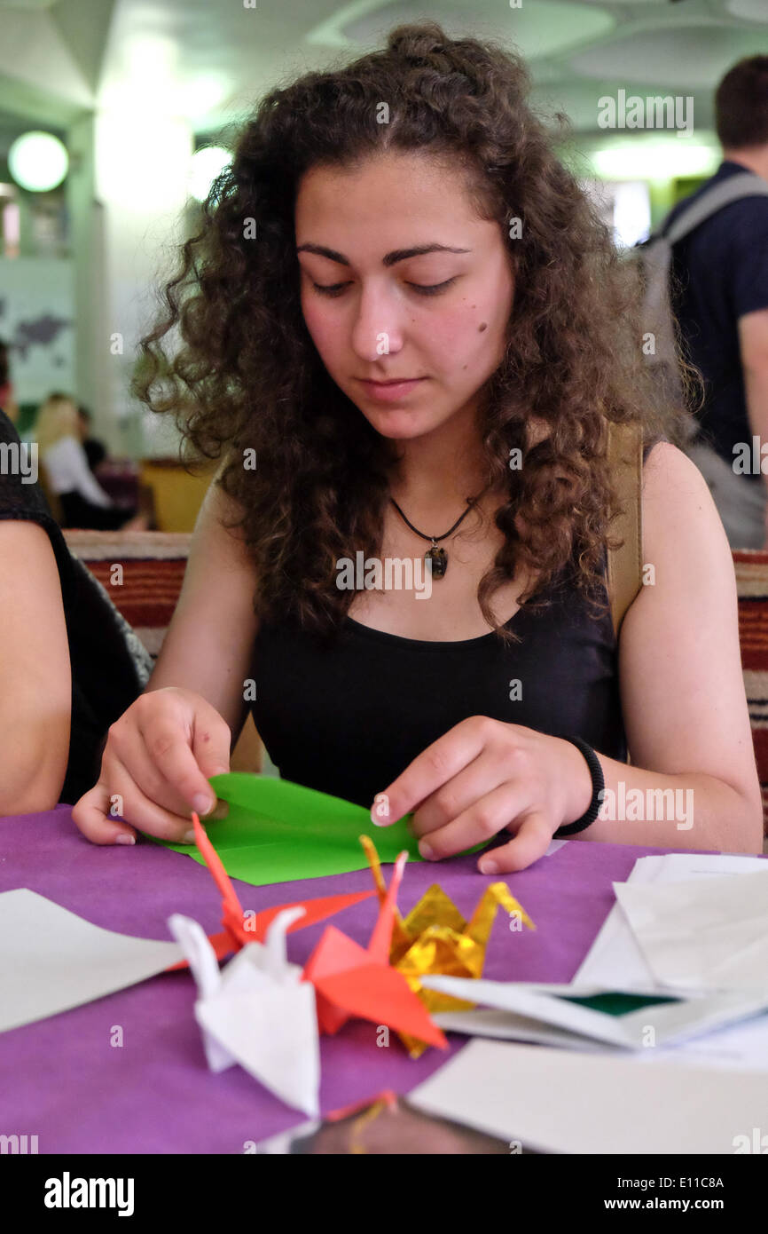 Students learning how to make origami hi-res stock photography and ...