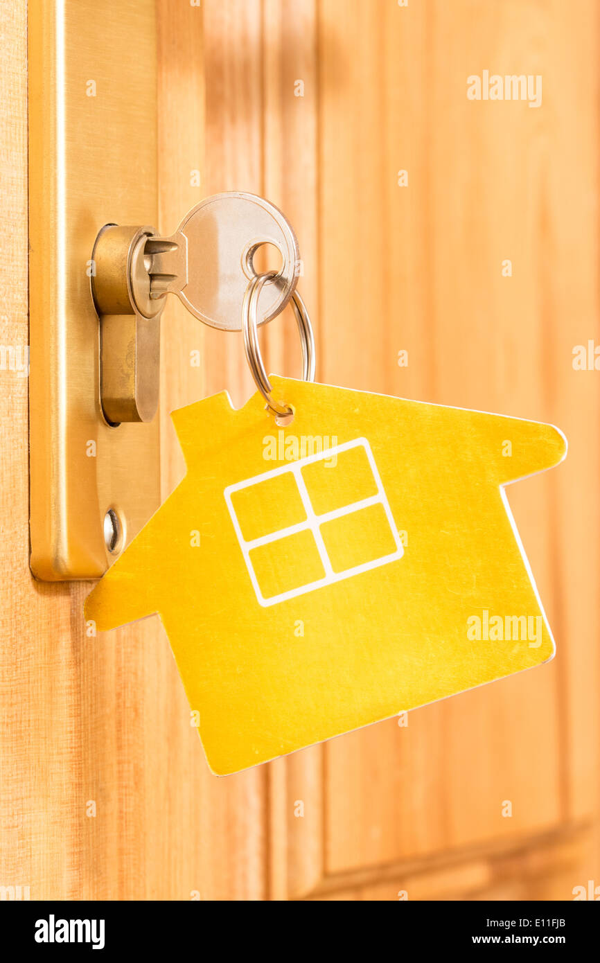Symbol of the house and stick the key in the keyhole Stock Photo - Alamy