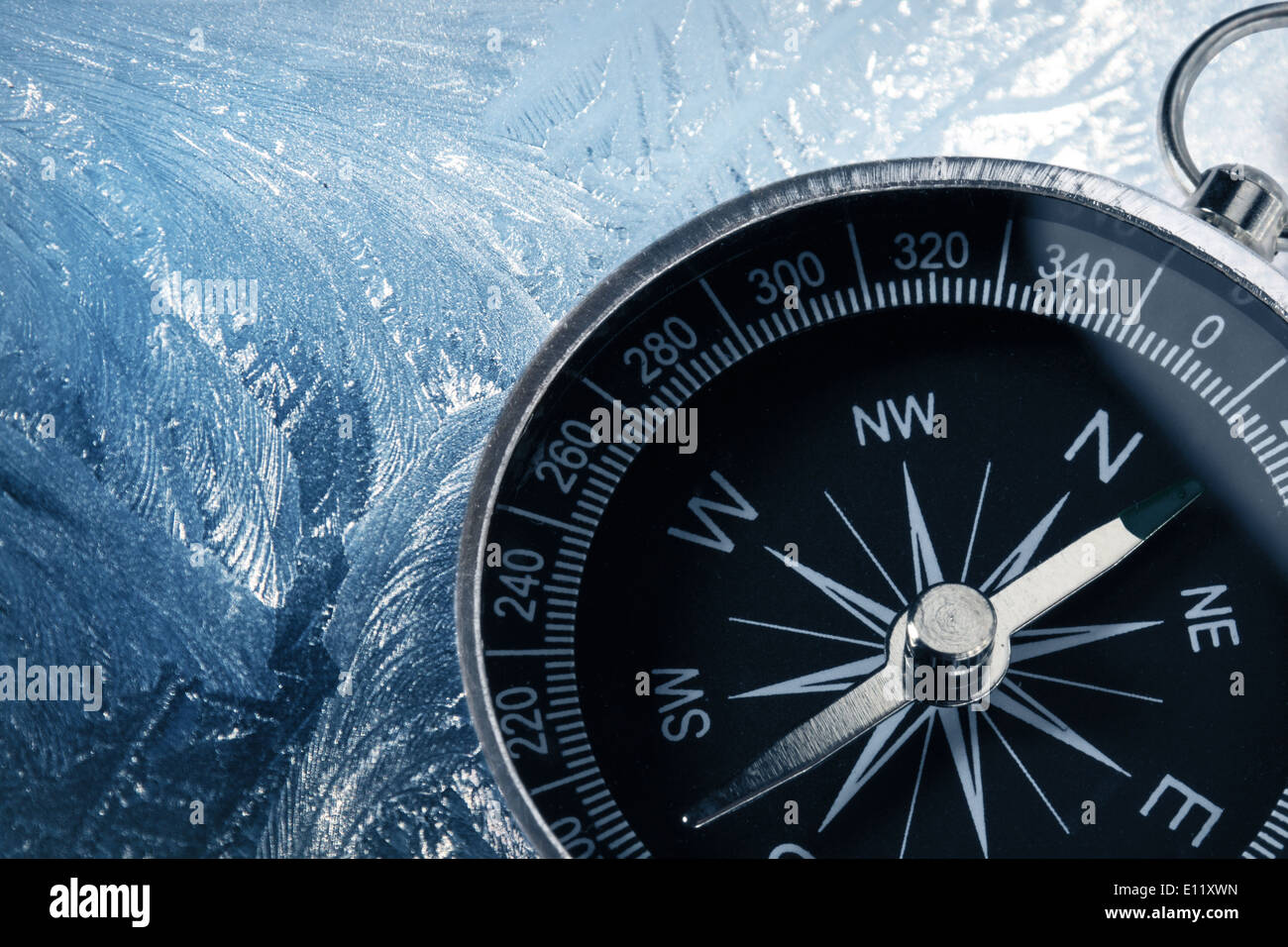 Black compass on icy background Stock Photo - Alamy