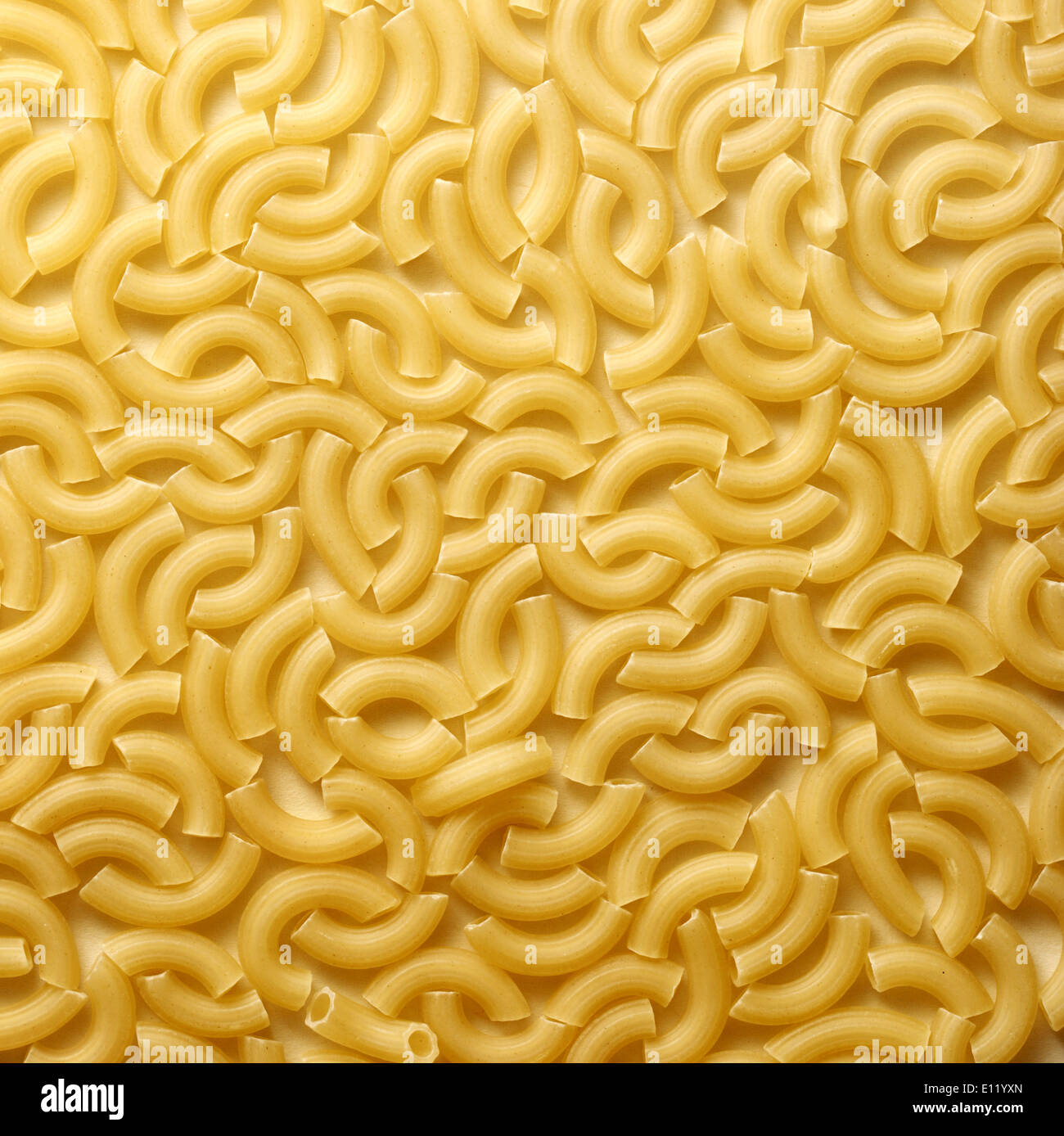 Short ribbed pasta tubes background Stock Photo - Alamy