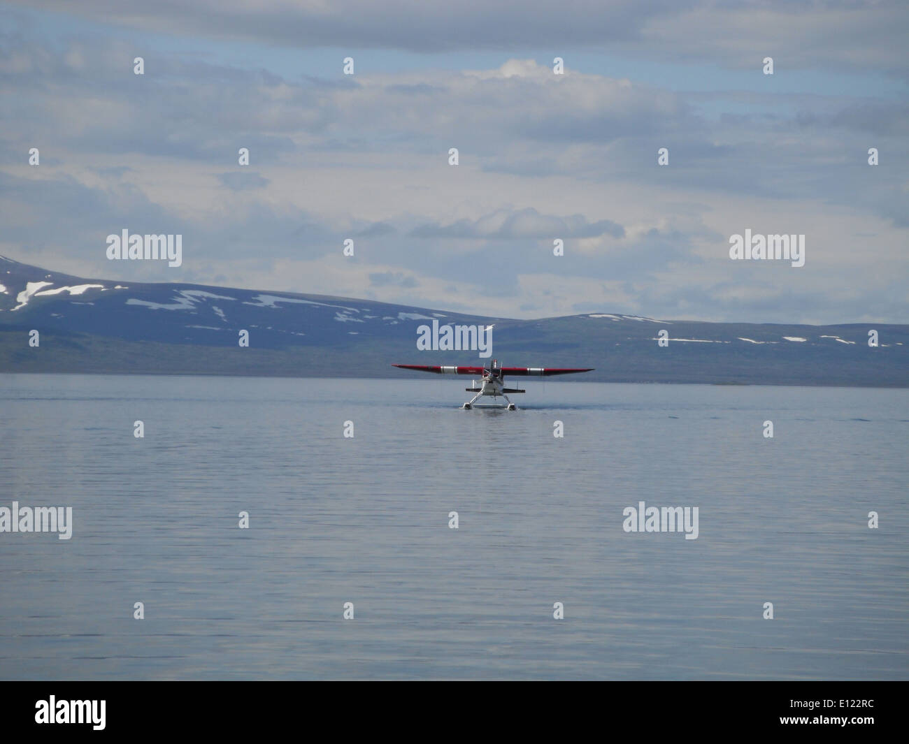 A float plane flies over the Ugashik Narrows in Alaska, a remote and ...
