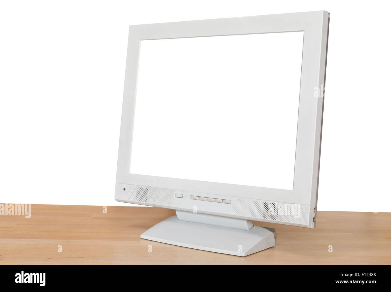 side view of grey computer display with cutout screen on wood table ...