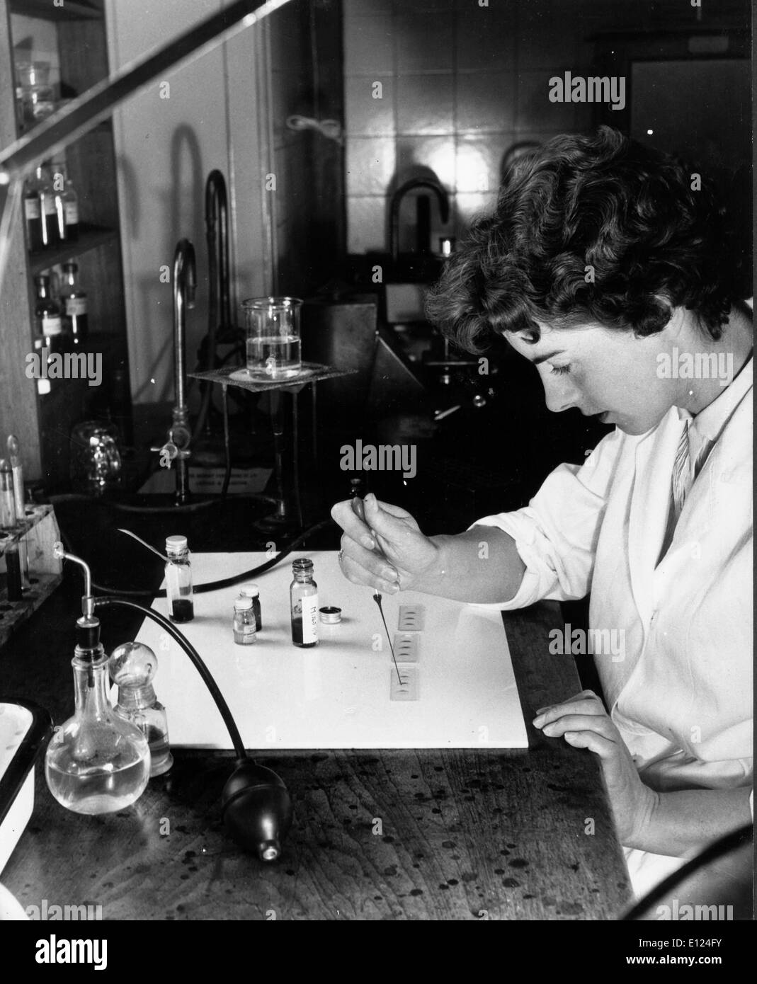 Scotland Yard - A serologist tests two blood samples of recent victims ...