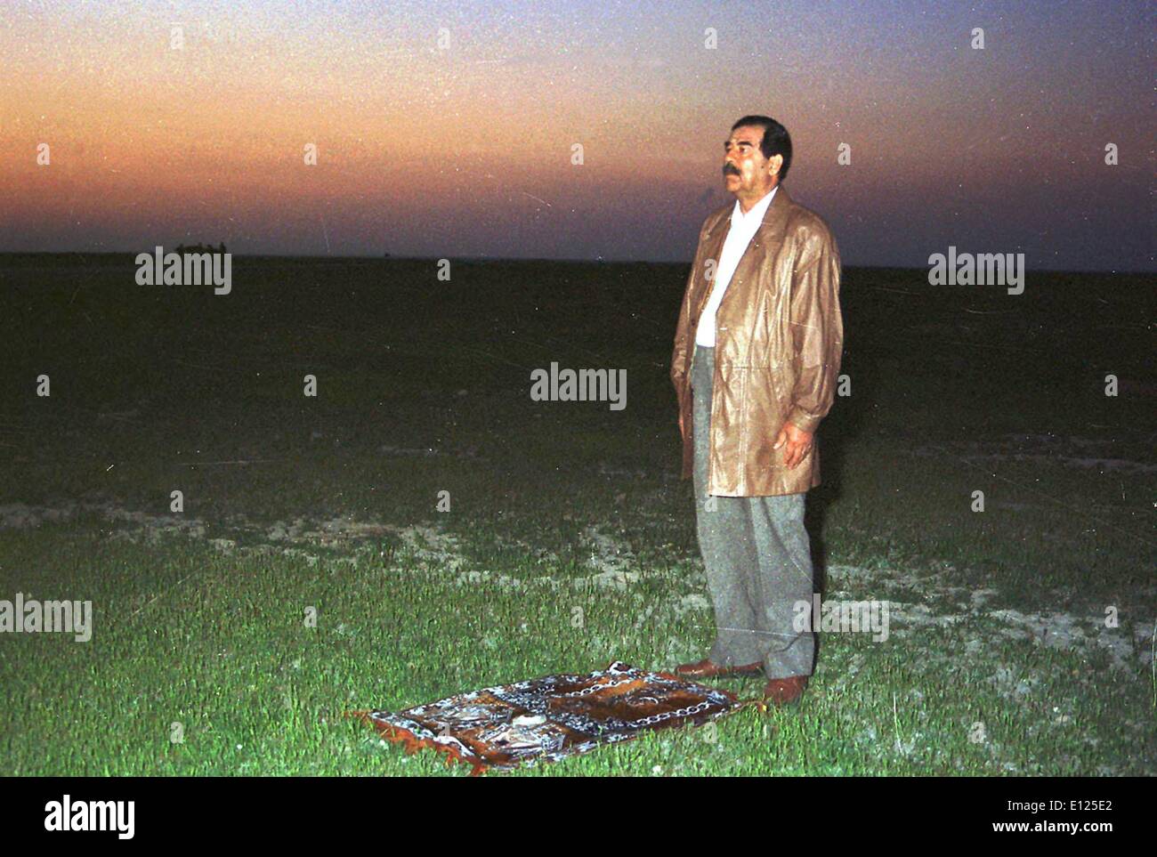Iraqi Dictator SADDAM HUSSEIN - Praying at a roadside after his visit ...