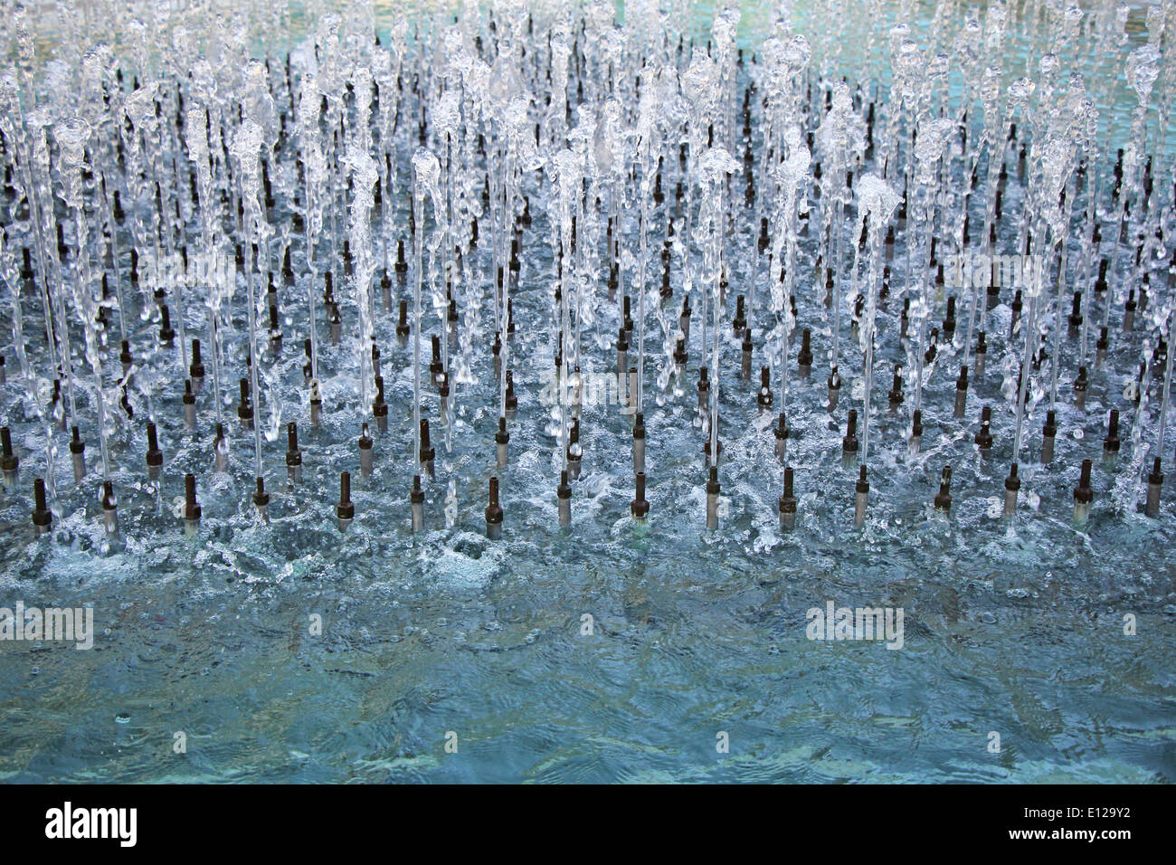 Water stream splashing from the many fountains pipe Stock Photo - Alamy