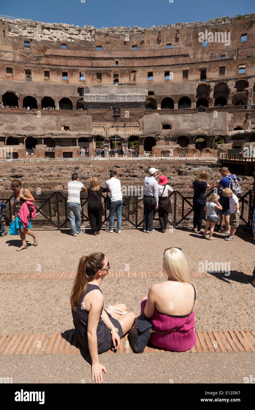 Rome tourism; Two women tourists on holiday visiting the Colosseum ...