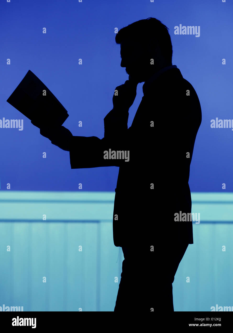 Handsome man reading the magazine Stock Photo - Alamy