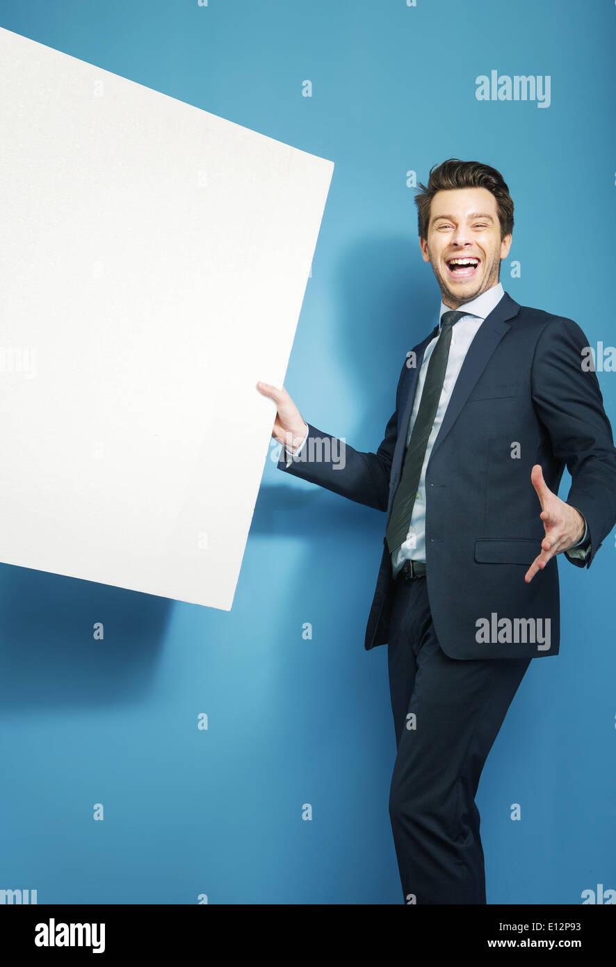 Funny handsome guy holding the white board Stock Photo - Alamy