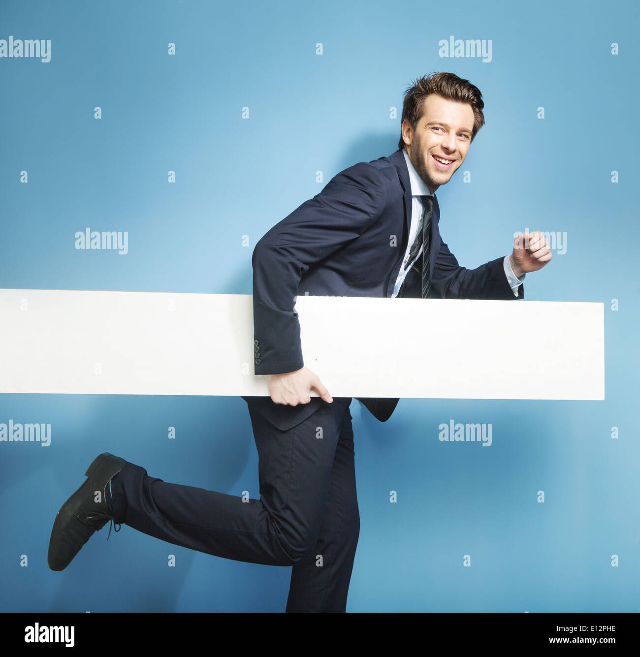 Elegant young man running with the commercial board Stock Photo - Alamy