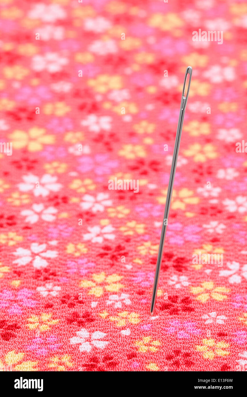 sewing needle on cloth of flower pattern Stock Photo - Alamy