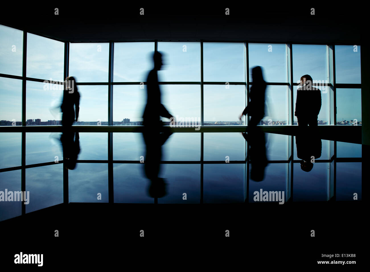 Silhouettes of several office workers on background of window Stock ...