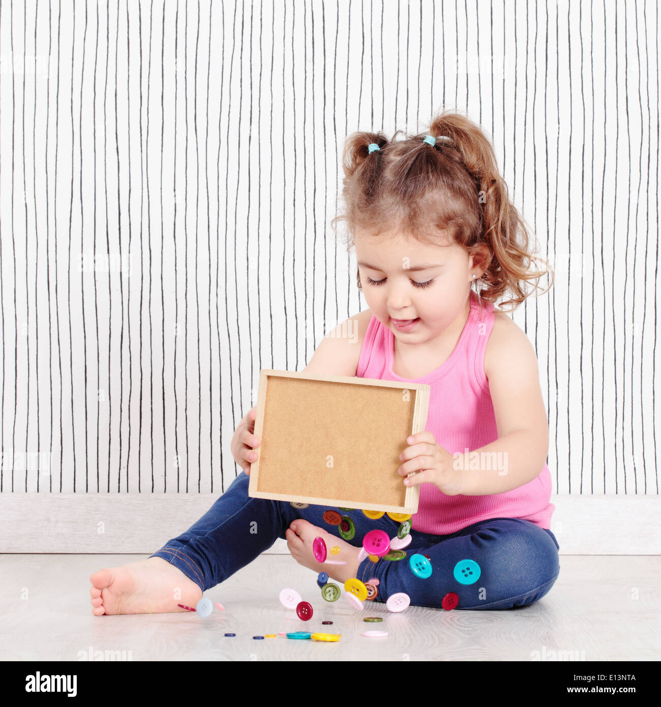 happy girl playing with some buttons Stock Photo - Alamy