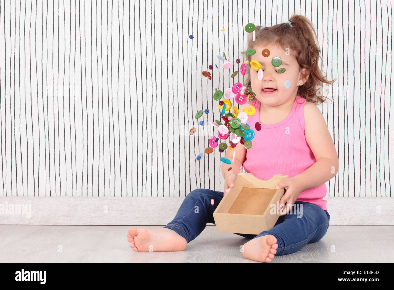 happy girl playing with some buttons Stock Photo - Alamy