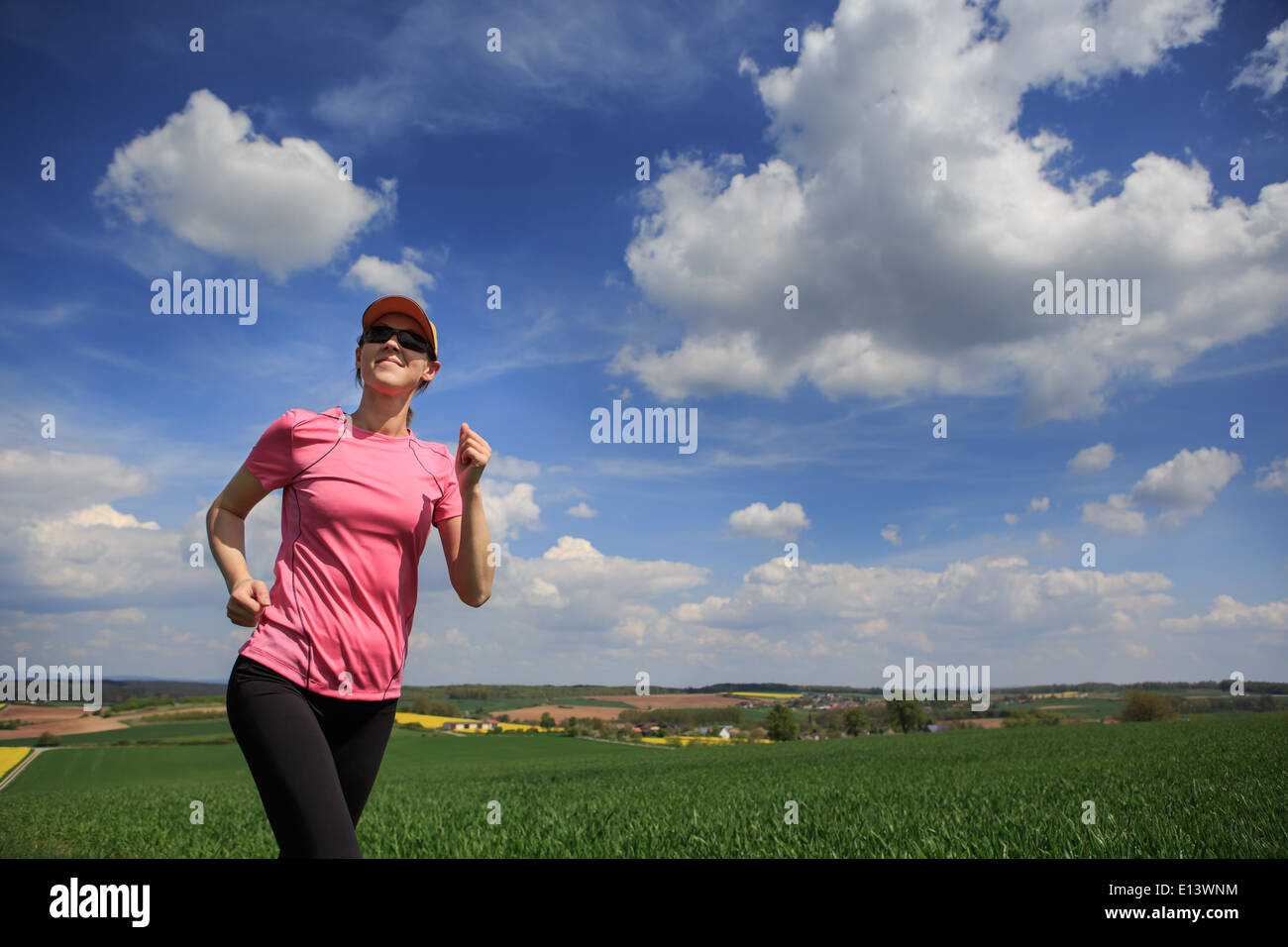 woman jogging through fields at the springtime Stock Photo - Alamy