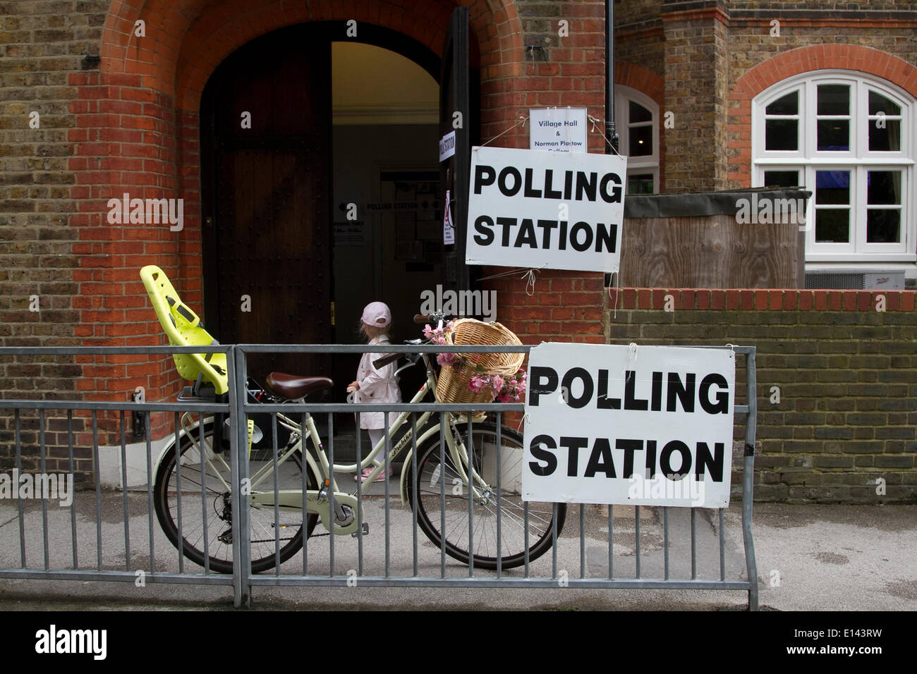 Wimbledon London,UK. 22nd May 2014. A child looks inside a polling ...