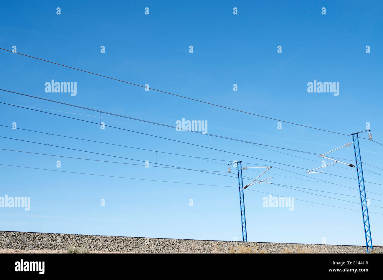 view of a railway catenary with blue sky Stock Photo - Alamy