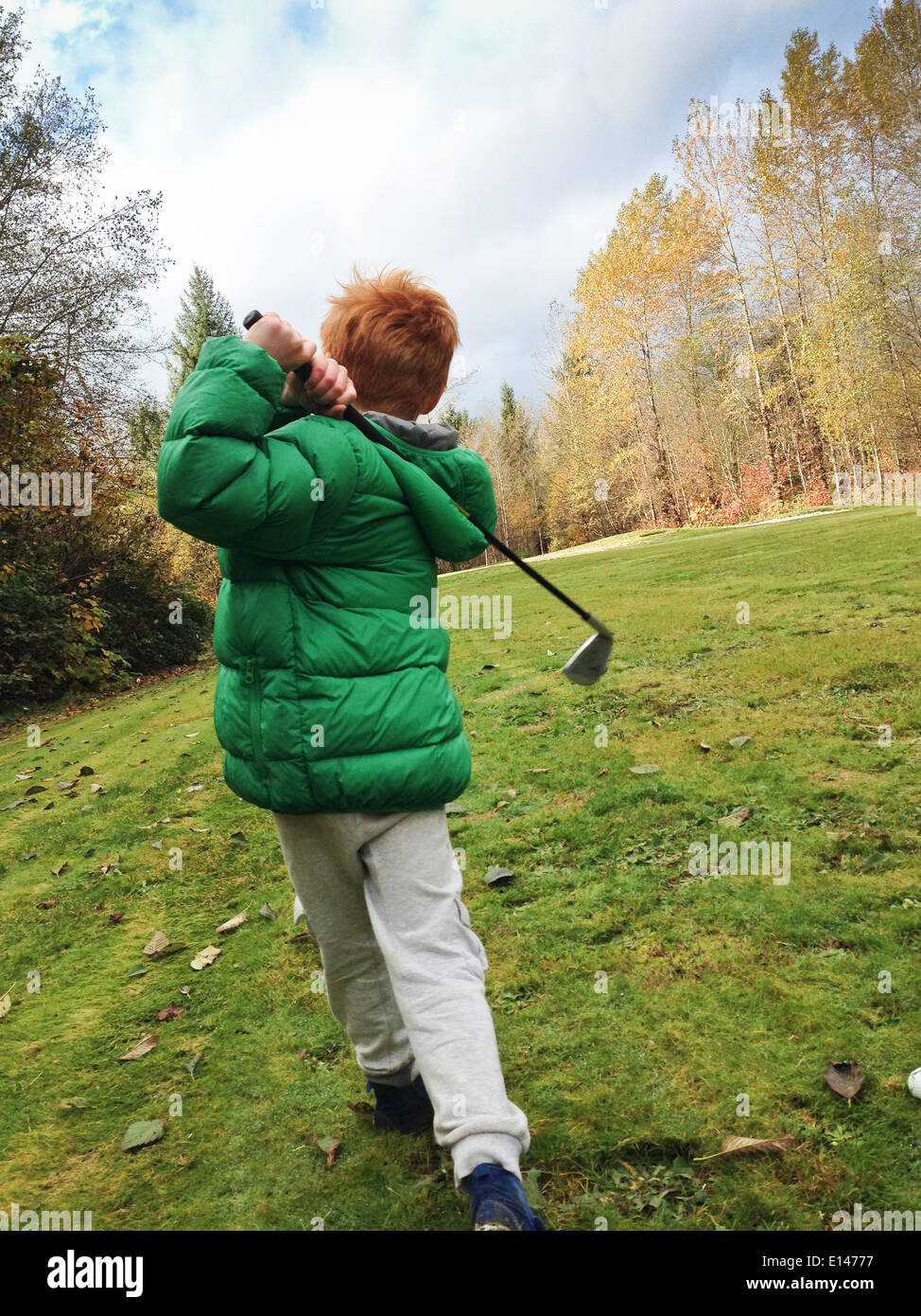 Boy playing golf in park Stock Photo - Alamy