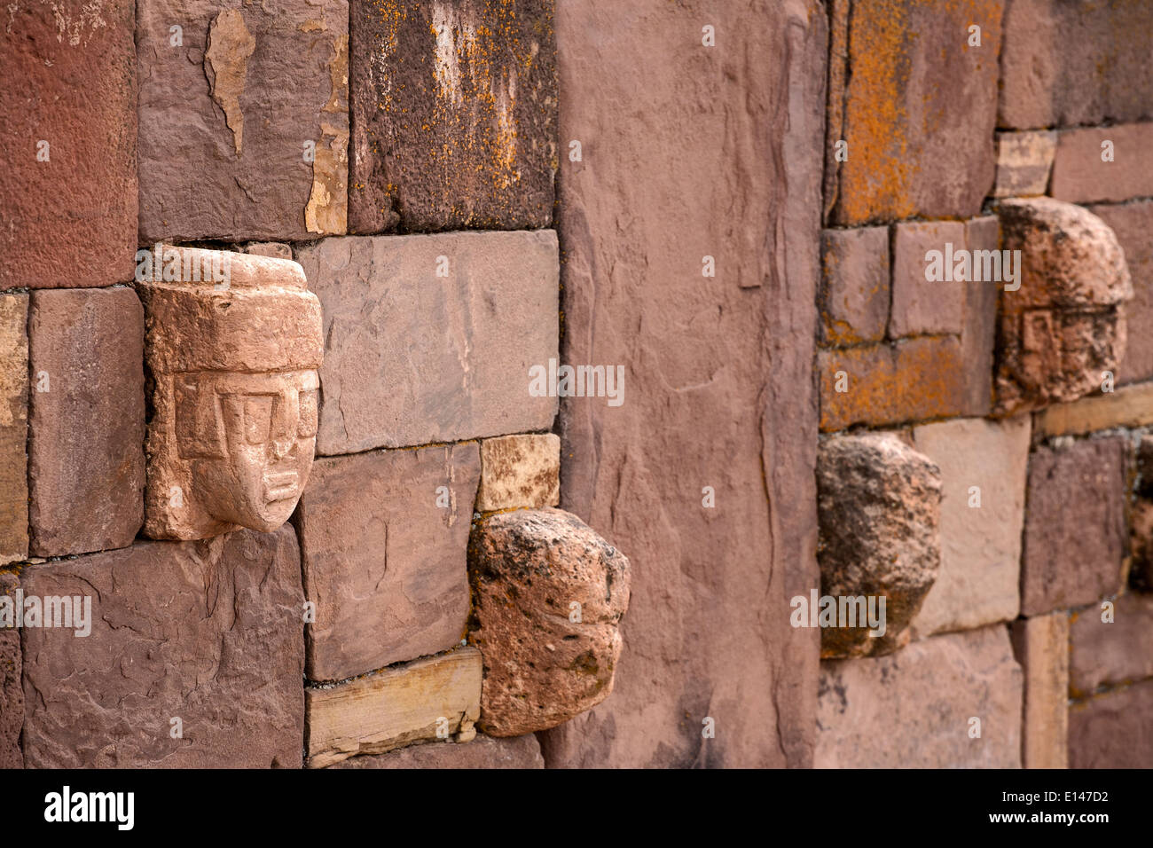 Carved stone tenon-heads embedded in wall of the semi-subterranean ...