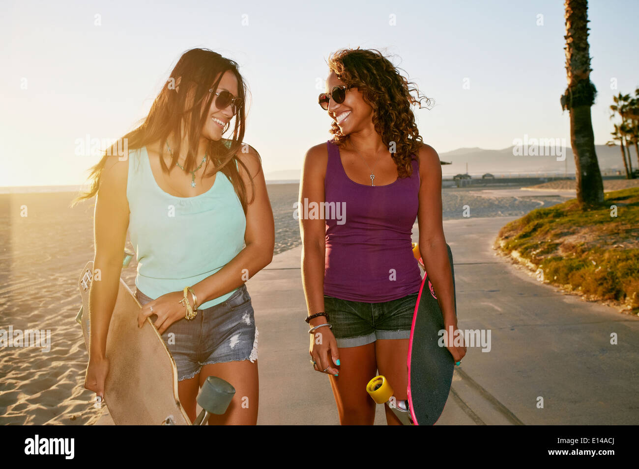 Young woman riding longboard hi-res stock photography and images - Alamy