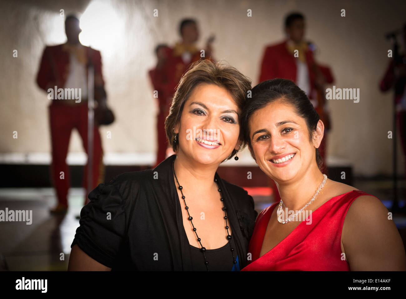 Hispanic women smiling at wedding reception Stock Photo - Alamy