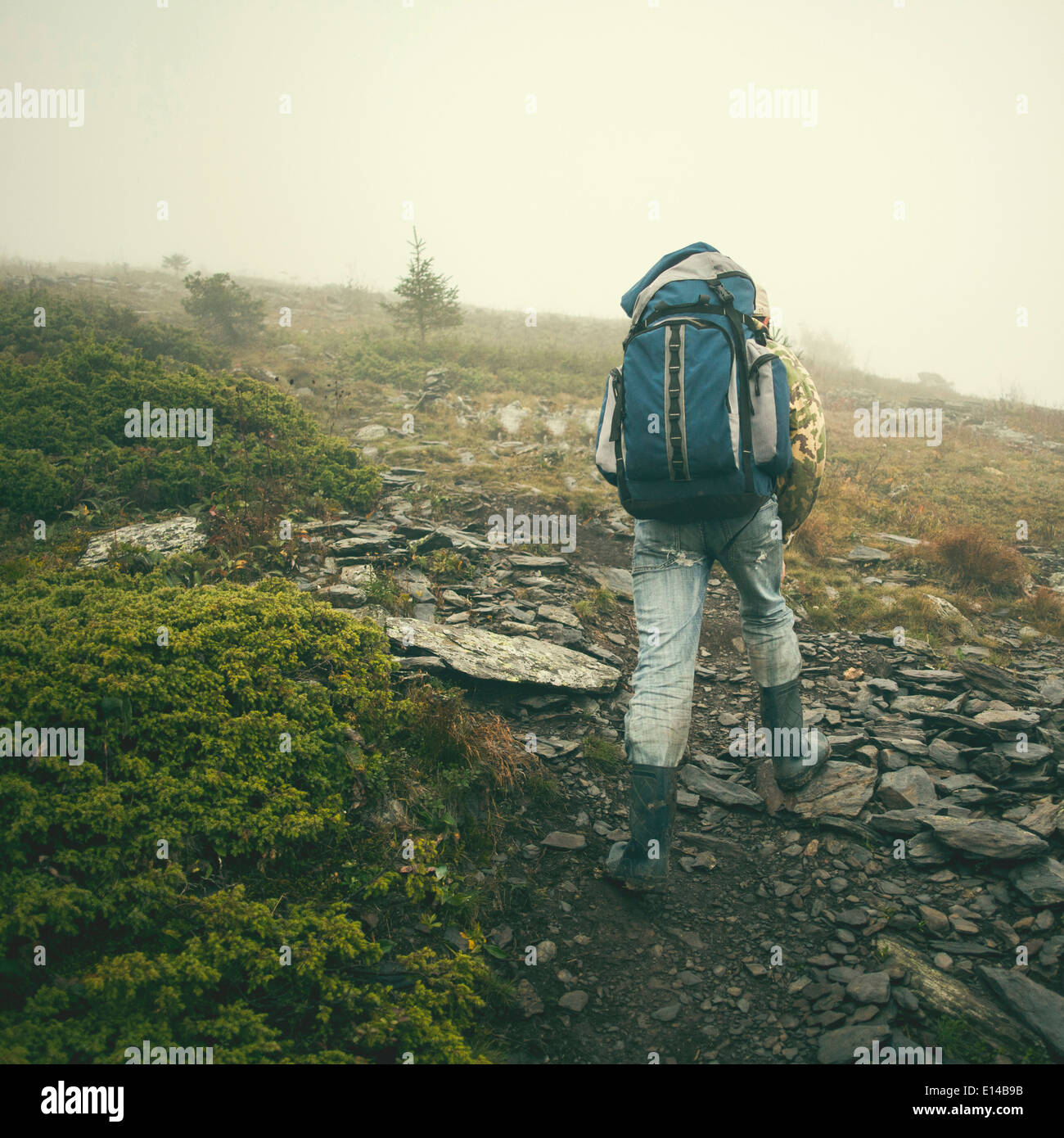 Mari man hiking on rocky hillside Stock Photo - Alamy