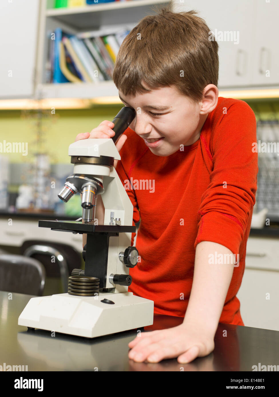 Caucasian boy using microscope in chemistry lab Stock Photo - Alamy