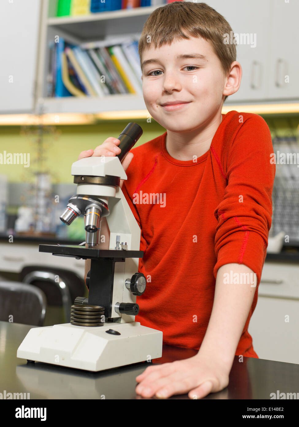 Caucasian boy using microscope in chemistry lab Stock Photo - Alamy