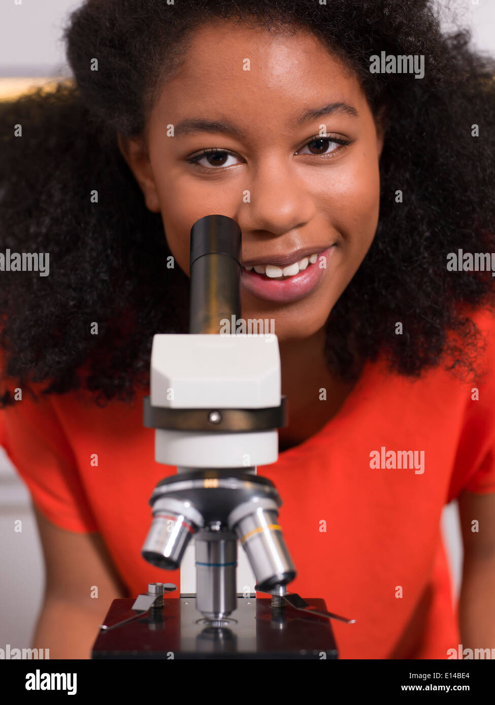 Black girl using microscope in chemistry lab Stock Photo - Alamy